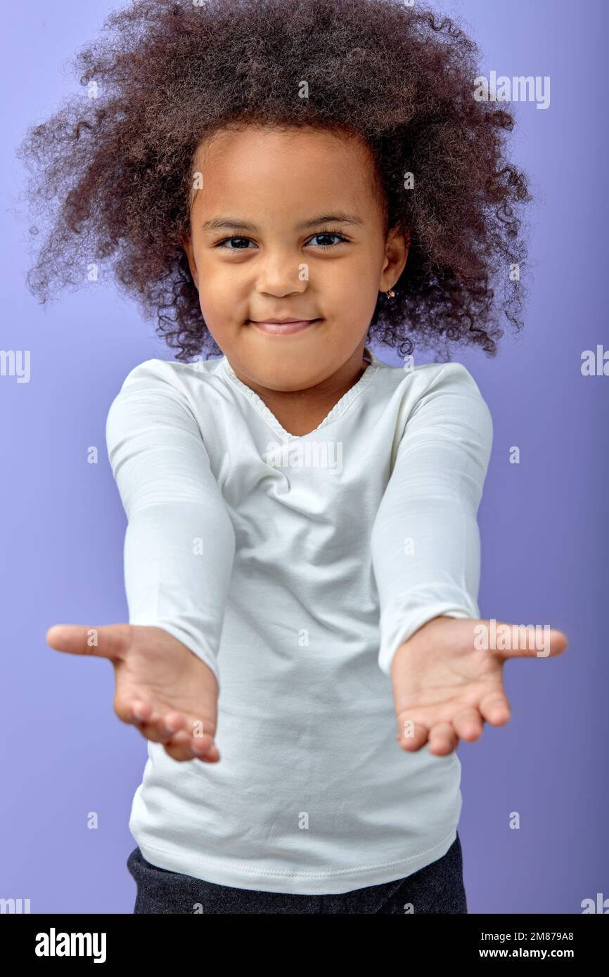 black cute girl stretches arms for a hug, kind adorable child smiling ...