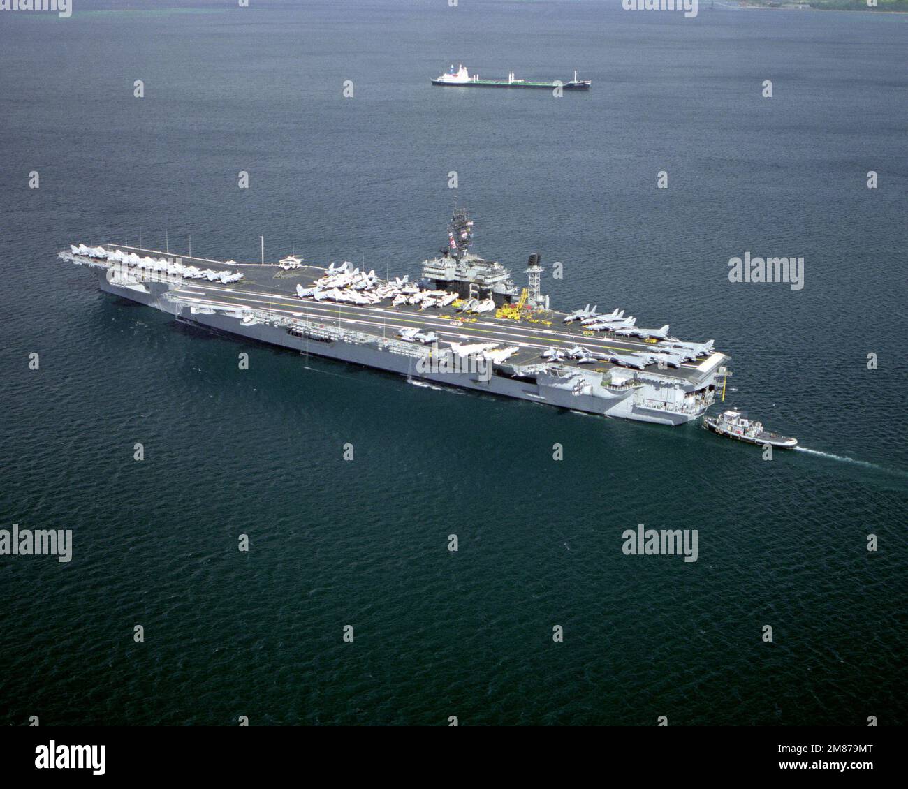 An aerial port quarter view of the aircraft carrier USS KITTY HAWK (CV ...