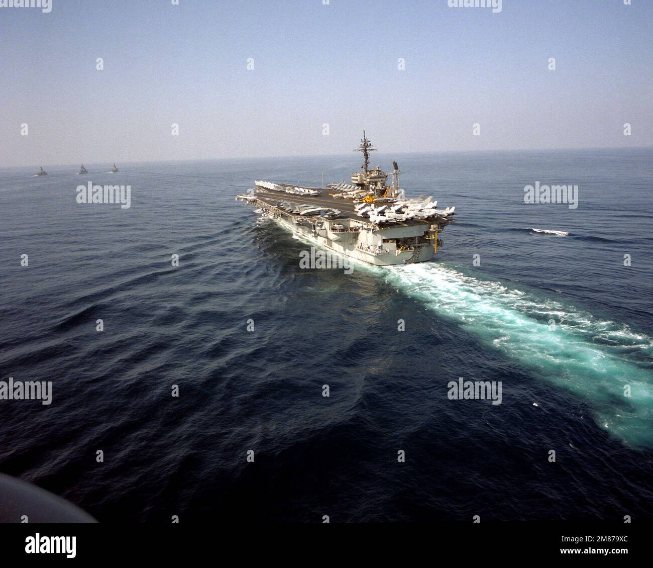 An aerial port quarter view of the aircraft carrier USS KITTY HAWK (CV ...