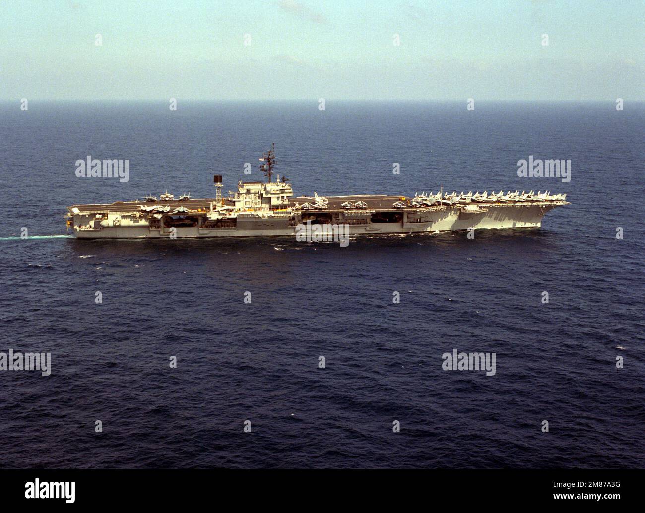 An aerial port view of the aircraft carrier USS KITTY HAWK (CV-63 ...