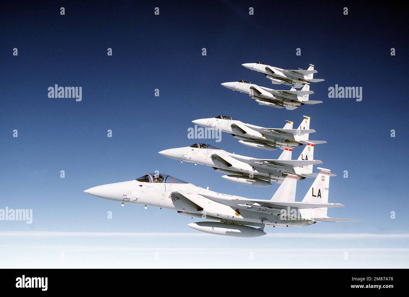 An air-to-air left side view of a flight of five F-15 "Eagles" flying ...