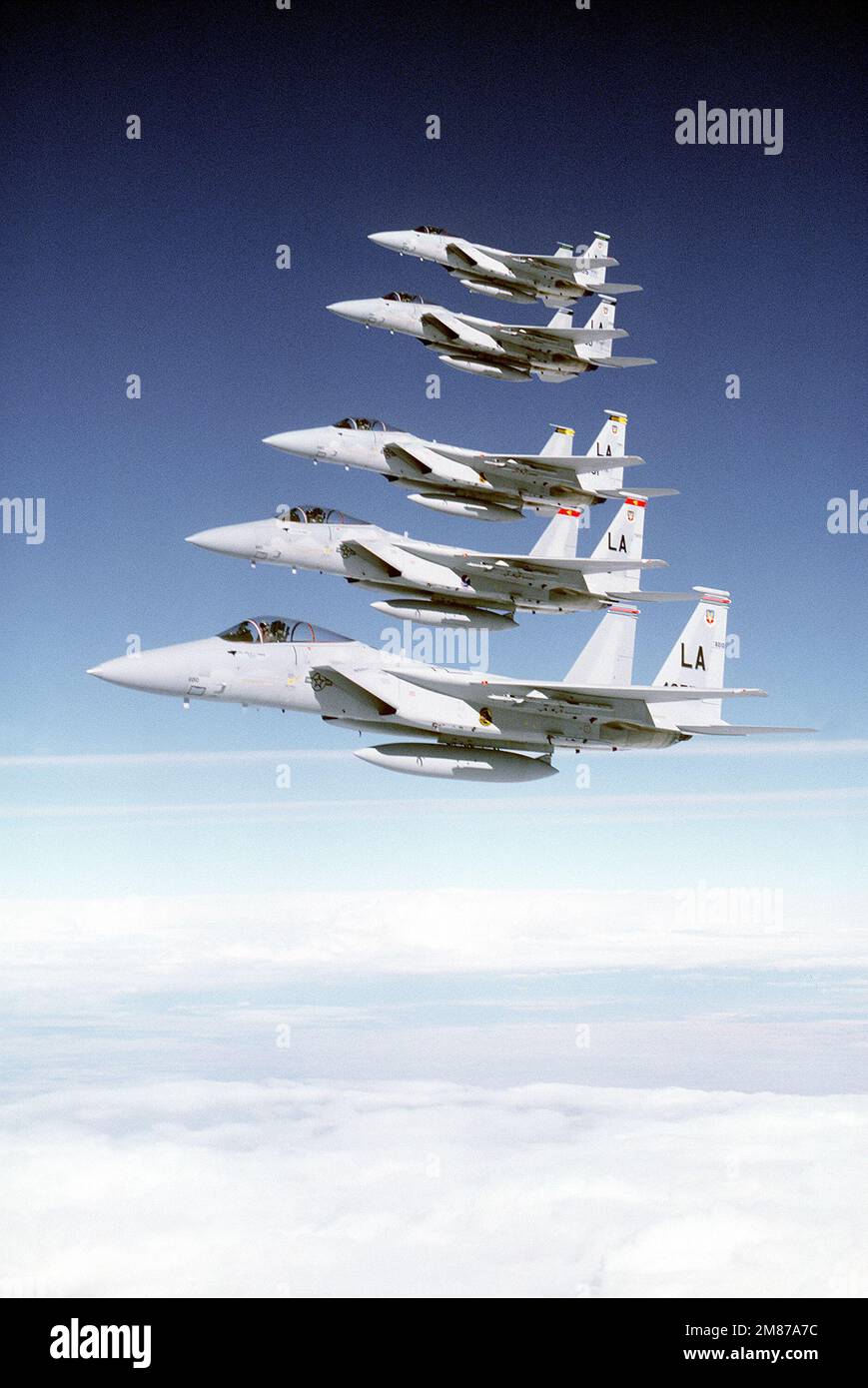 An air-to-air left side view of a flight of five F-15 "Eagles" flying ...