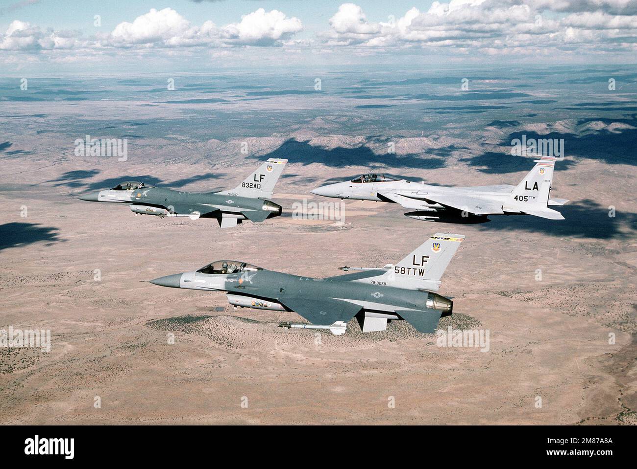 An air-to-air left side view of a flight of three Luke AFB fighters ...