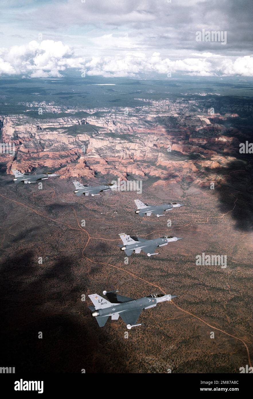 An air-to-air right side view of a flight of five F-16 "Fighting ...