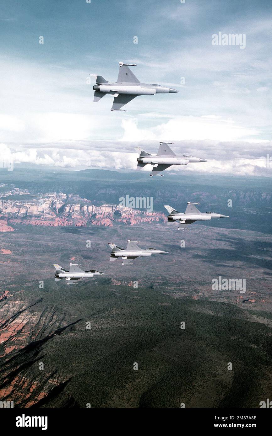 An air-to-air right side view of a flight of five F-16 "Fighting ...