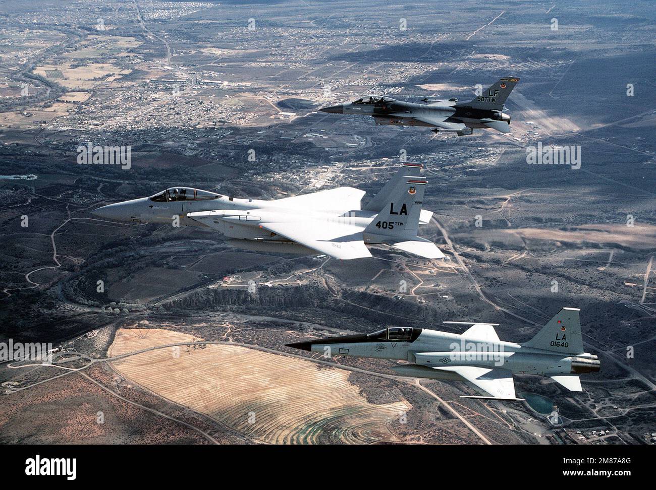 An air-to-air left side view of a flight of three Luke AFB fighters ...