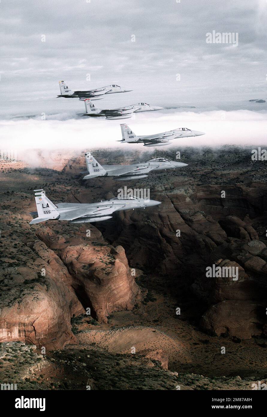 An air-to-air right side view of a flight of five F-15 "Eagles" flying ...