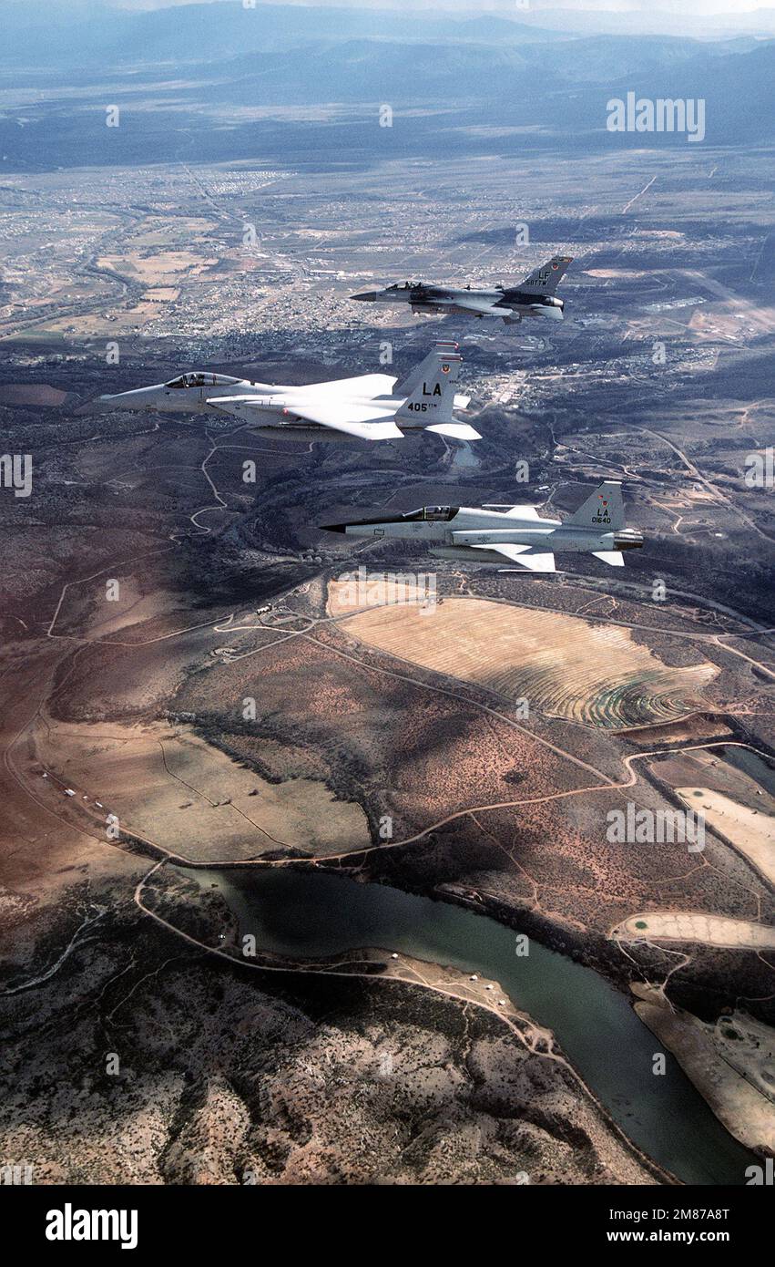 An air-to-air left side view of a flight of three Luke AFB fighters ...