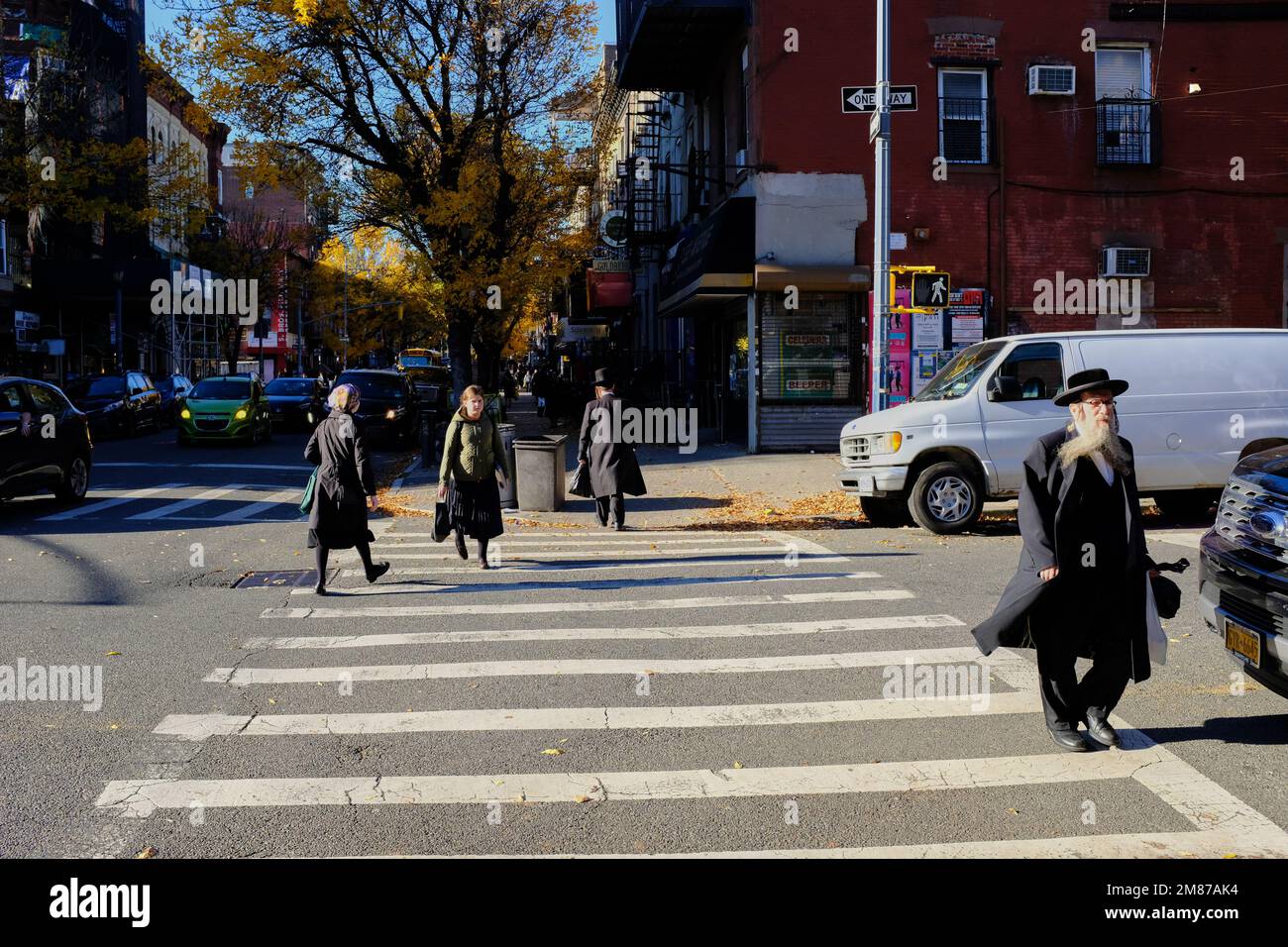 Orthodox Jewish men and women walking crossing Lee Avenue.Williamsburg ...