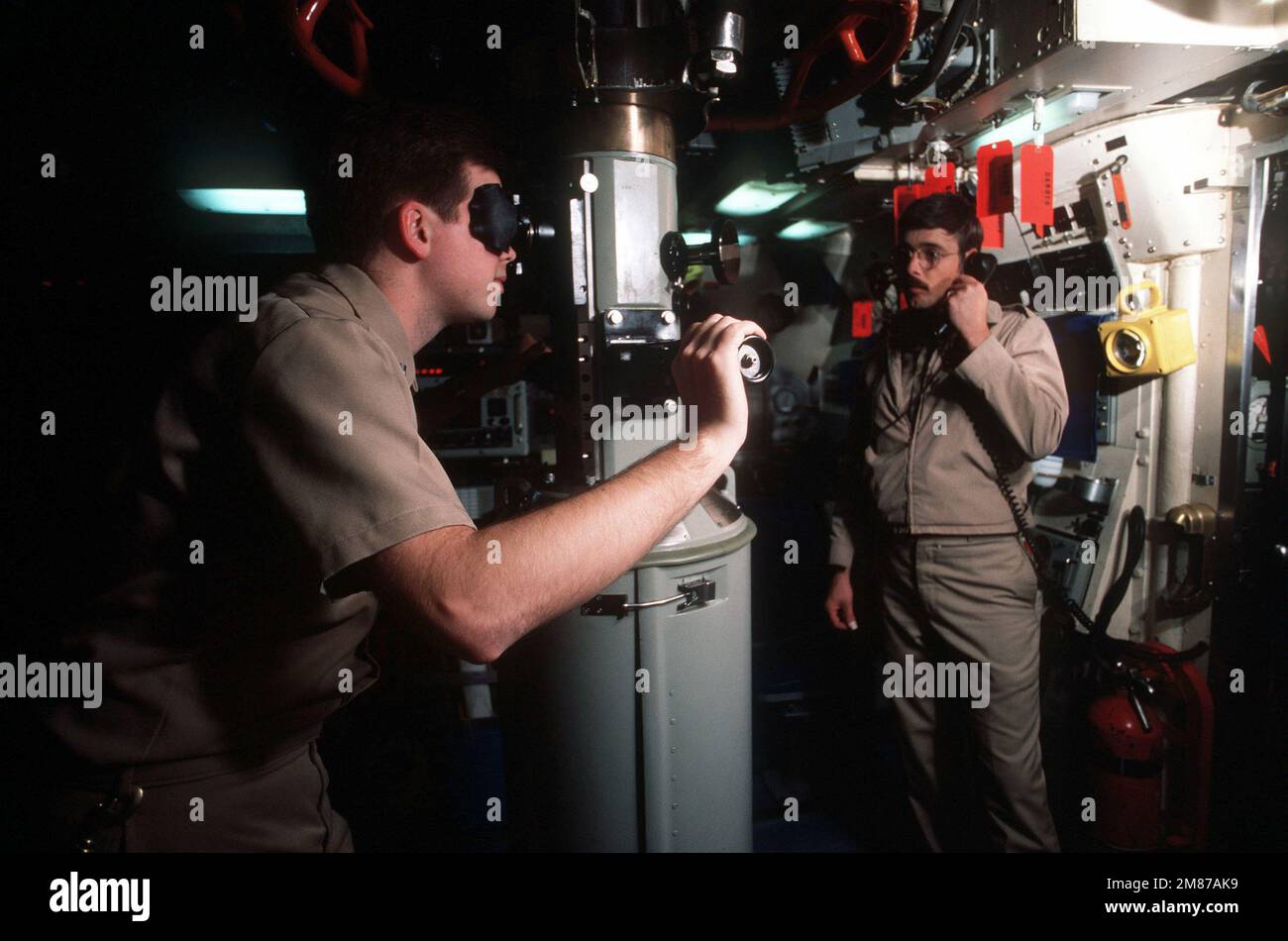 A lieutenant mans the periscope in the control room aboard the nuclear ...