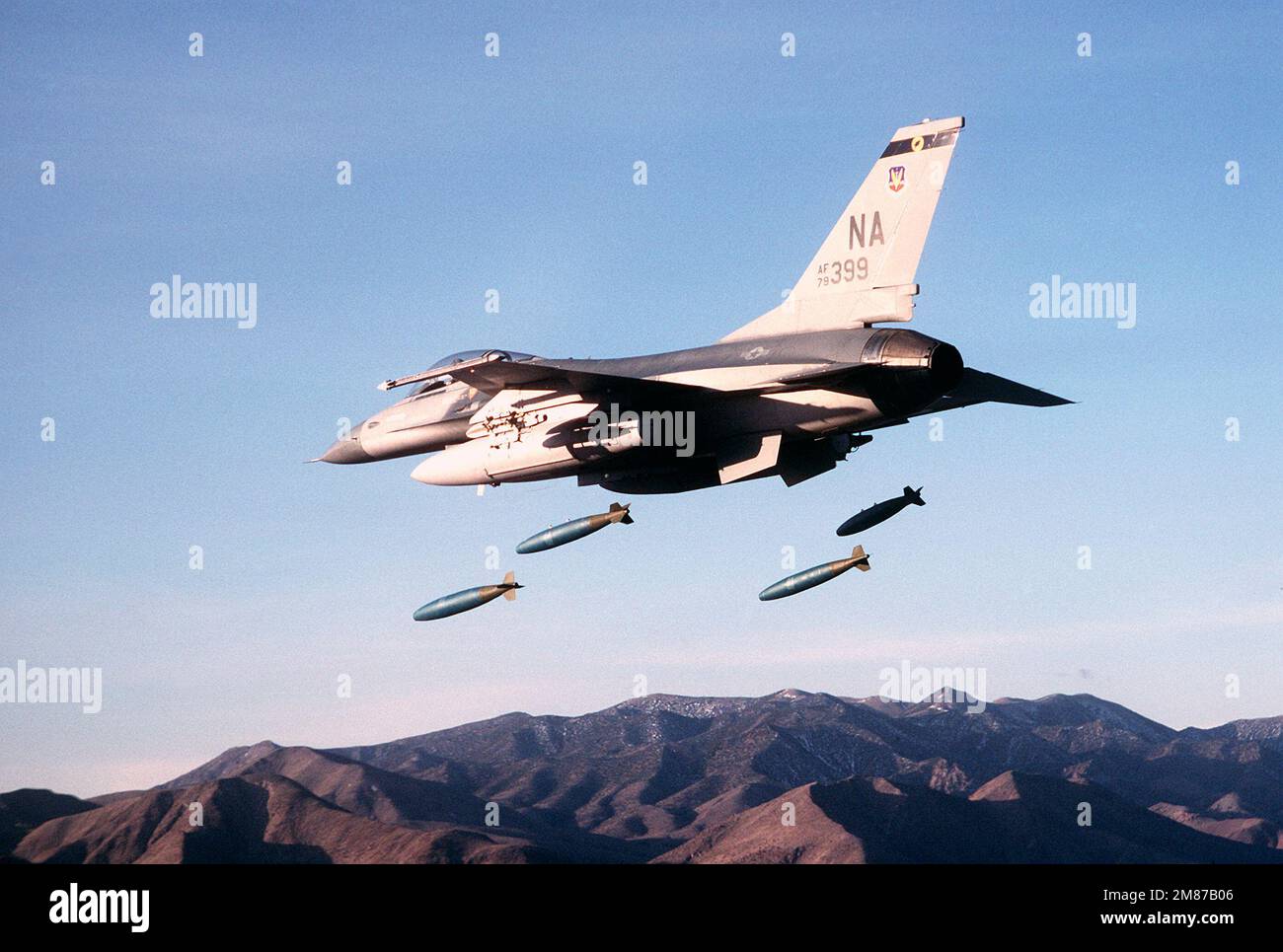 An air-to-air left underside view of an F-16 Fighting Falcon aircraft ...