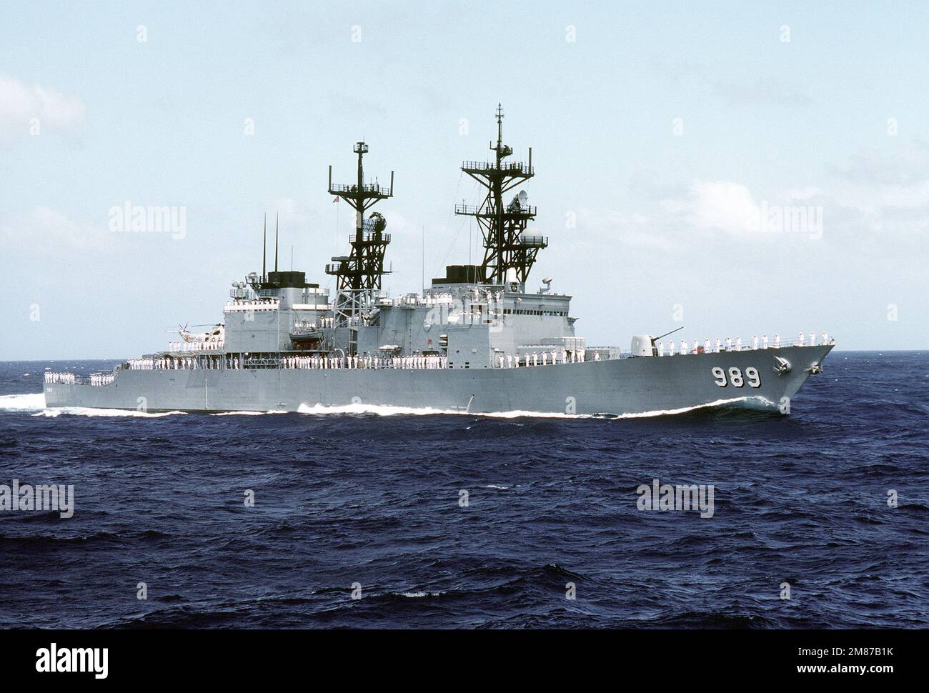 A starboard bow view of the destroyer USS DEYO (DD-989) underway. Crew ...