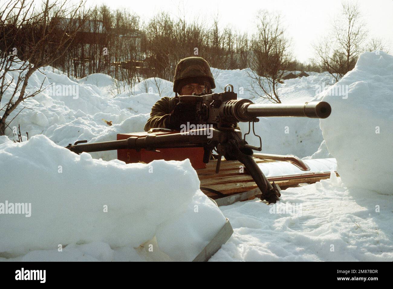 A Marine prepares to fire an M-2 .50-caliber machine gun during ...