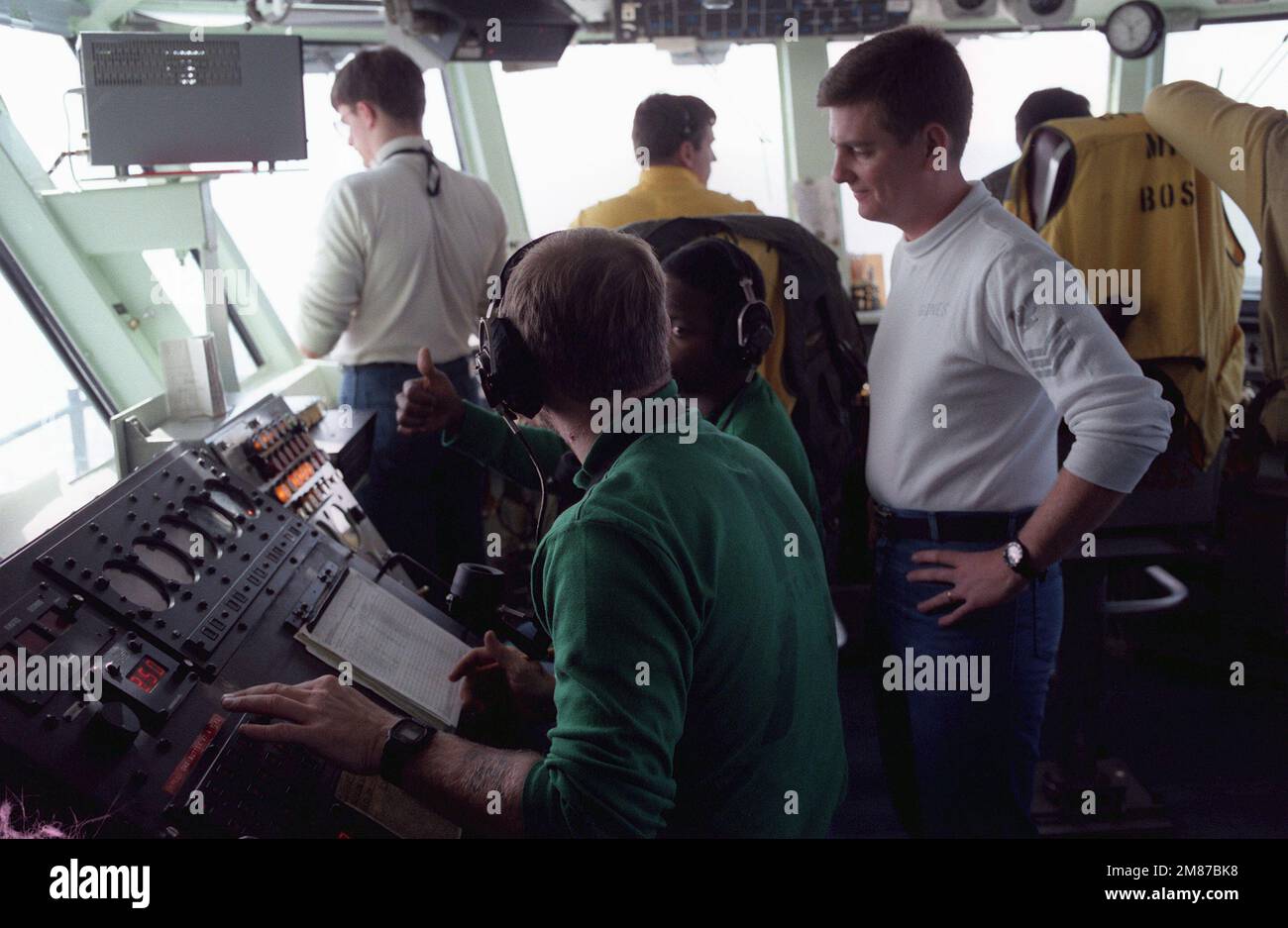 Crewmen tend to their duties in Pri-Fly, the primary control center ...