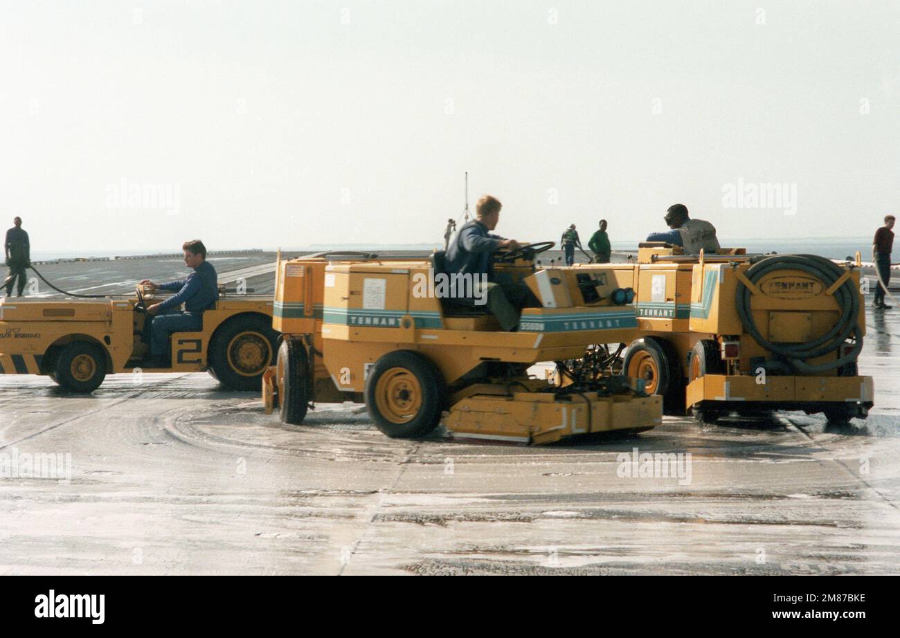 Mechanical sweepers are used to scrub the flight deck of the nuclear ...