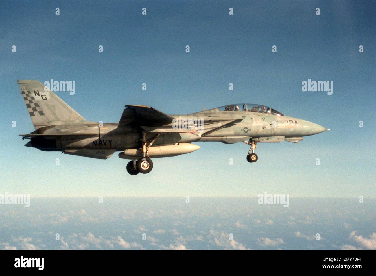 An air-to-air right side view of a Fighter Squadron 211 (VF-211) F-14A ...