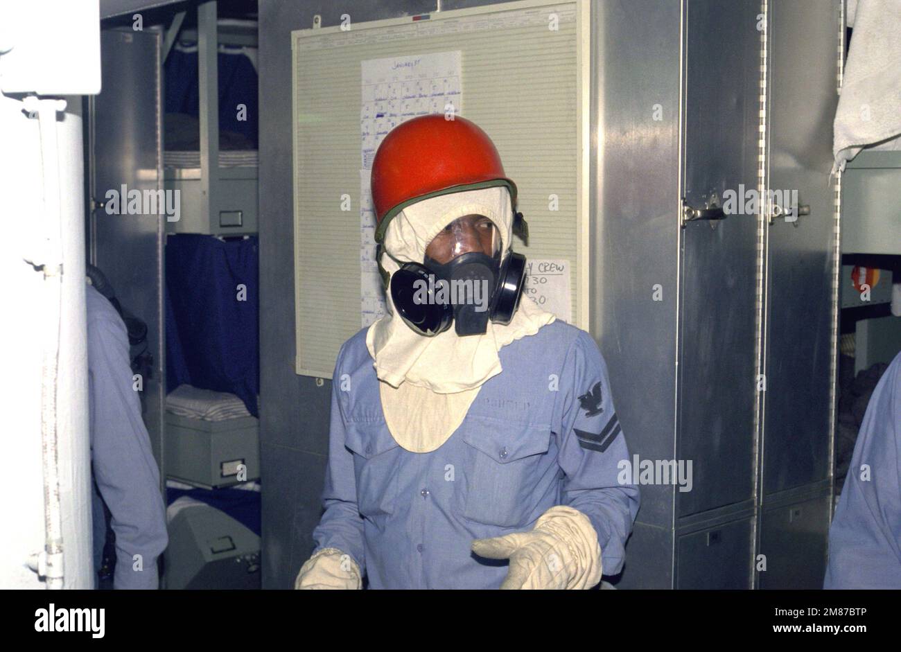 A sailor wears a Mark 5 protective mask during a general quarters drill ...