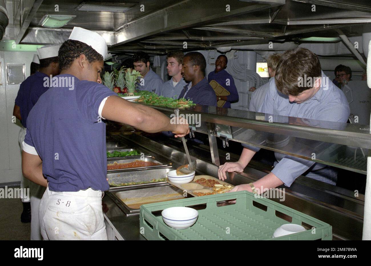 Crew members are served food in the mess of the nuclear-powered ...
