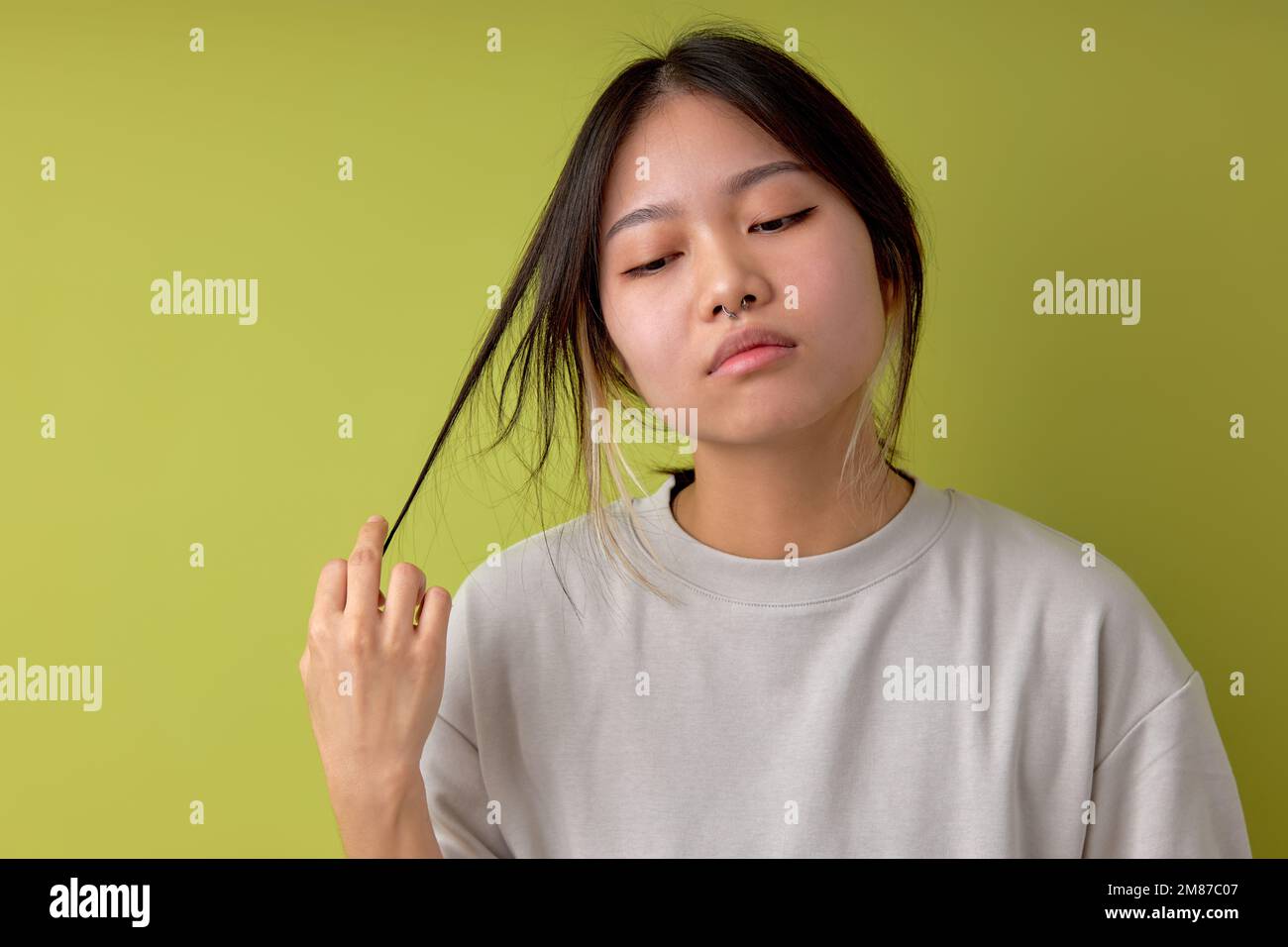 Portrait of asian sad woman touching hair, stand with thoughtful facial ...