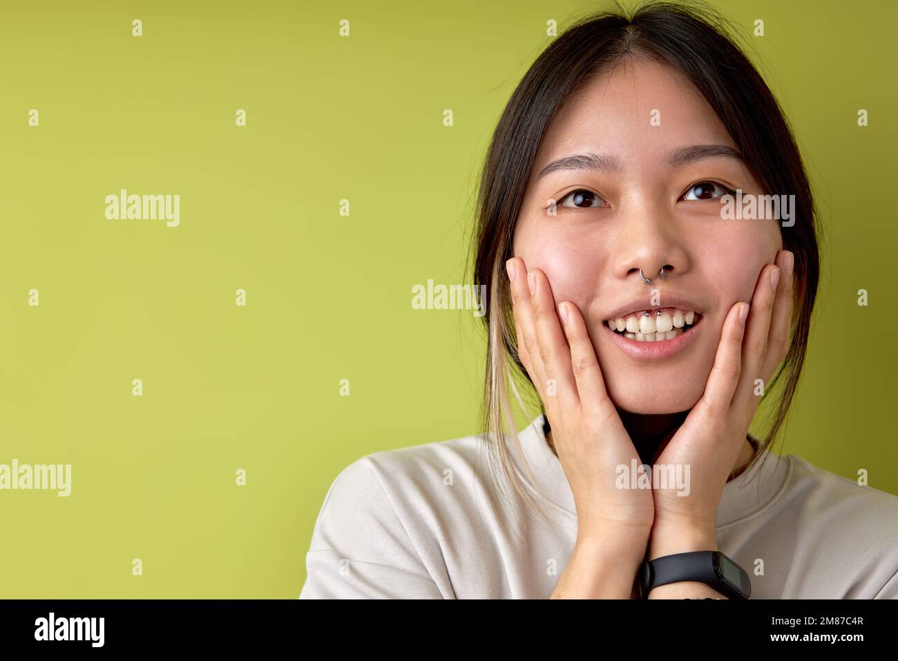 Korean female hand touch cheek looking on something with shocked and ...
