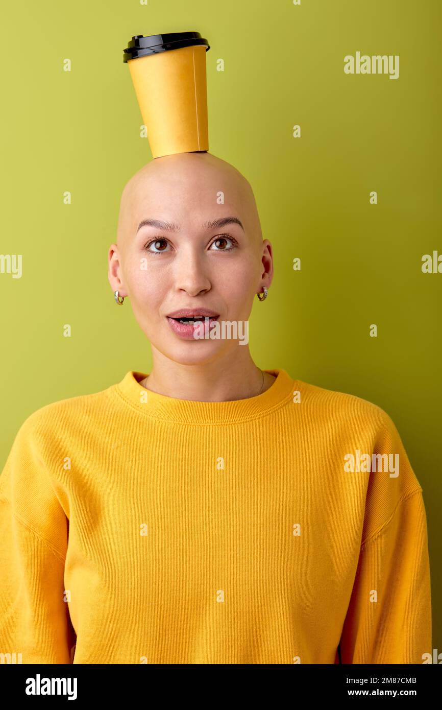 Frontal portrait of young bald caucasian european woman with cup of ...