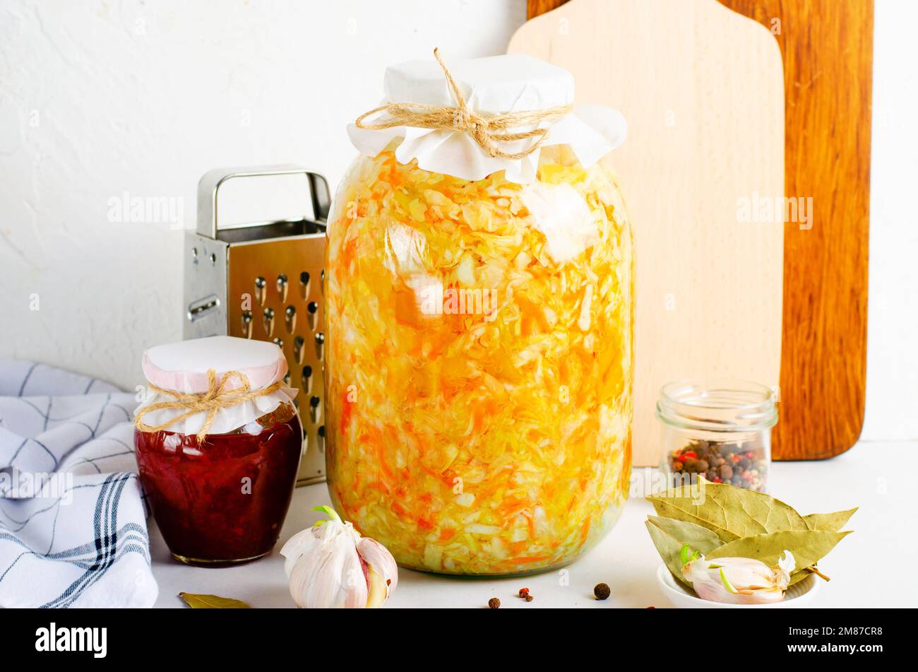 Sauerkraut, Shredded cabbage, apples, and carrots on bright rustic ...