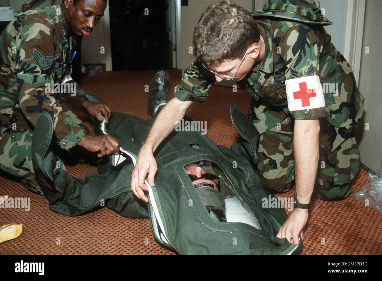 Members of the 1ST Aeromedical Evacuation Squadron secure a simualted ...