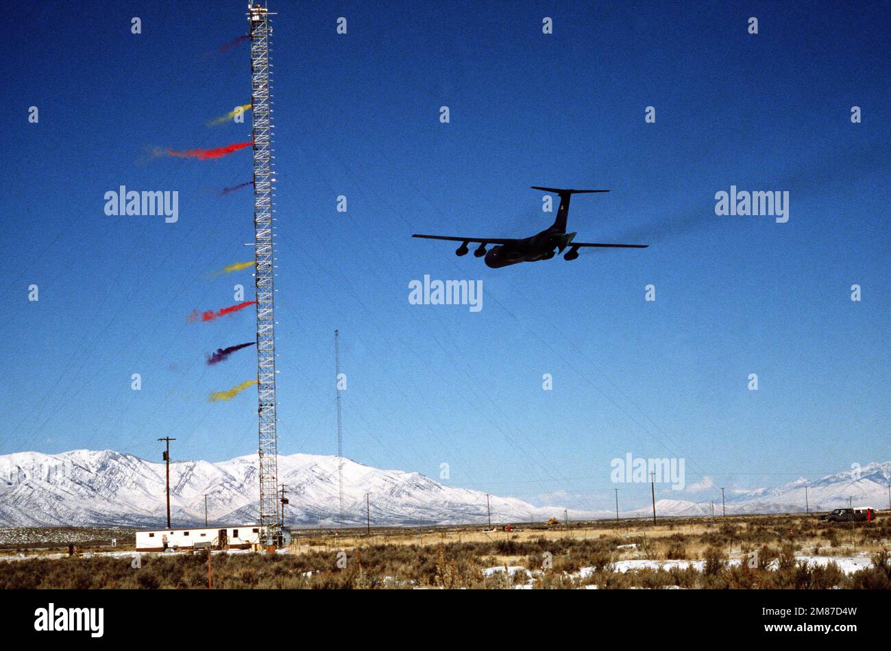 Colored smoke streams from smoke grenades mounted on a 210-foot tower ...