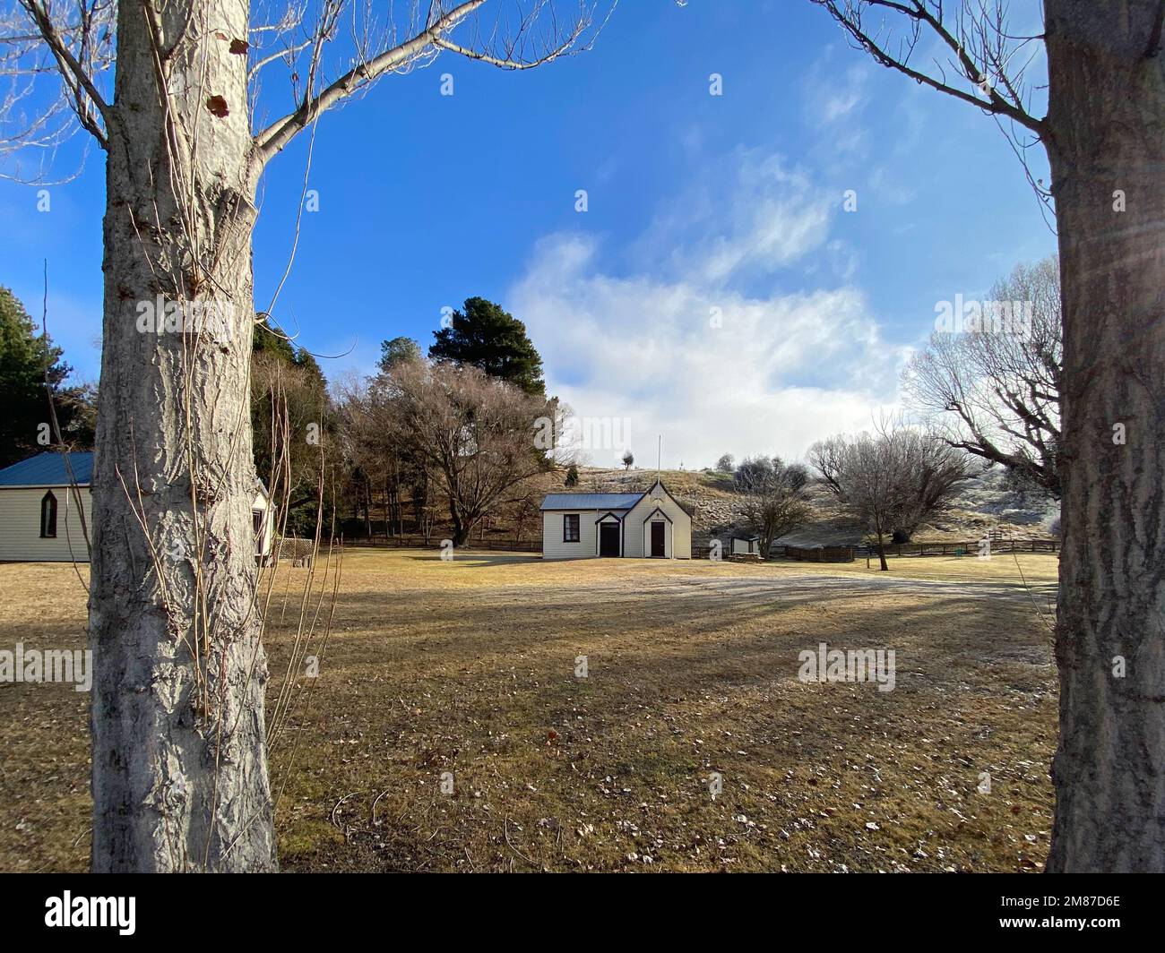 Cardrona village town hall with grass lawn and a picket fence viewed ...