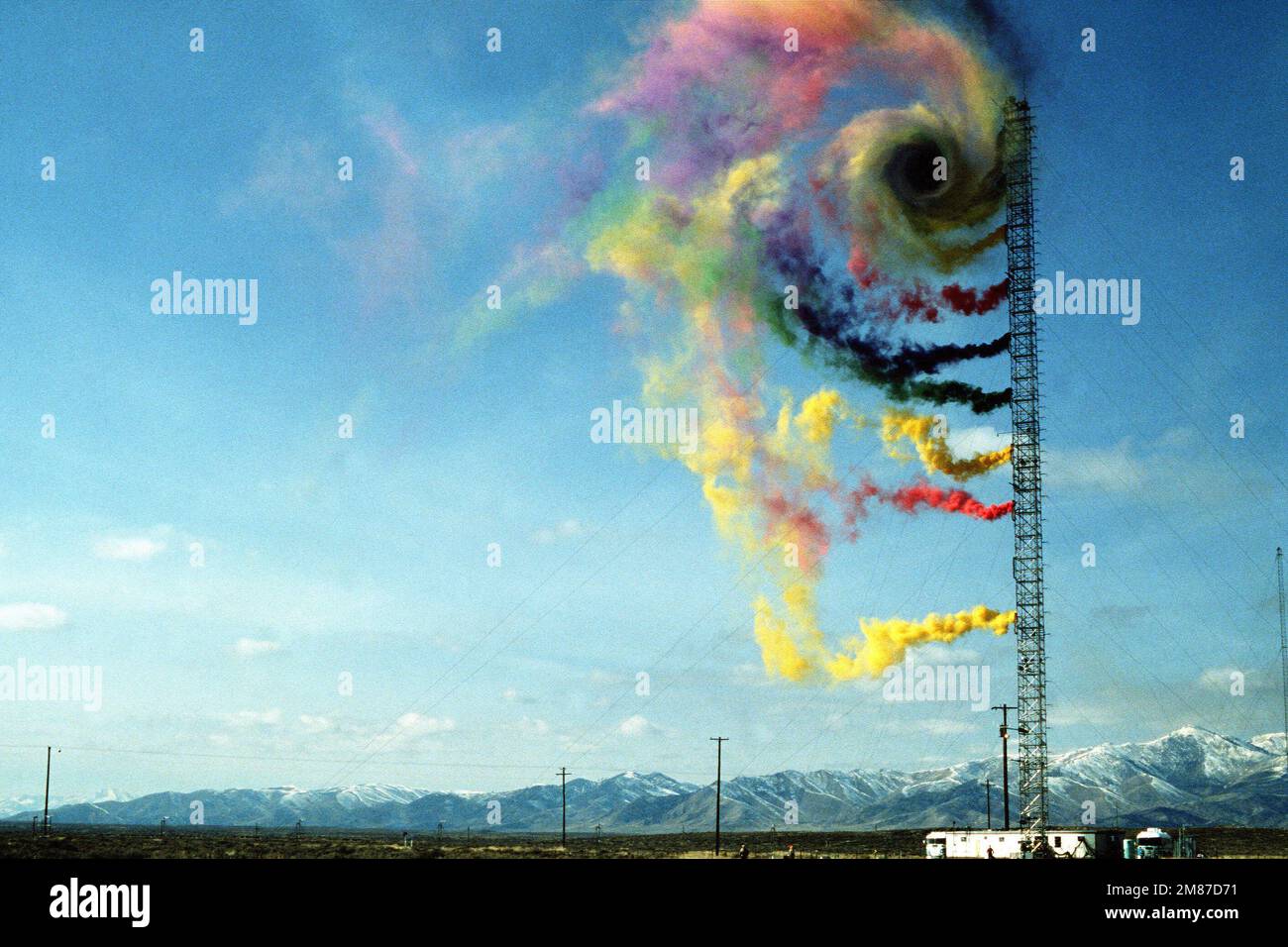 Colored smoke streams from smoke grenades mounted on a 210-foot tower ...