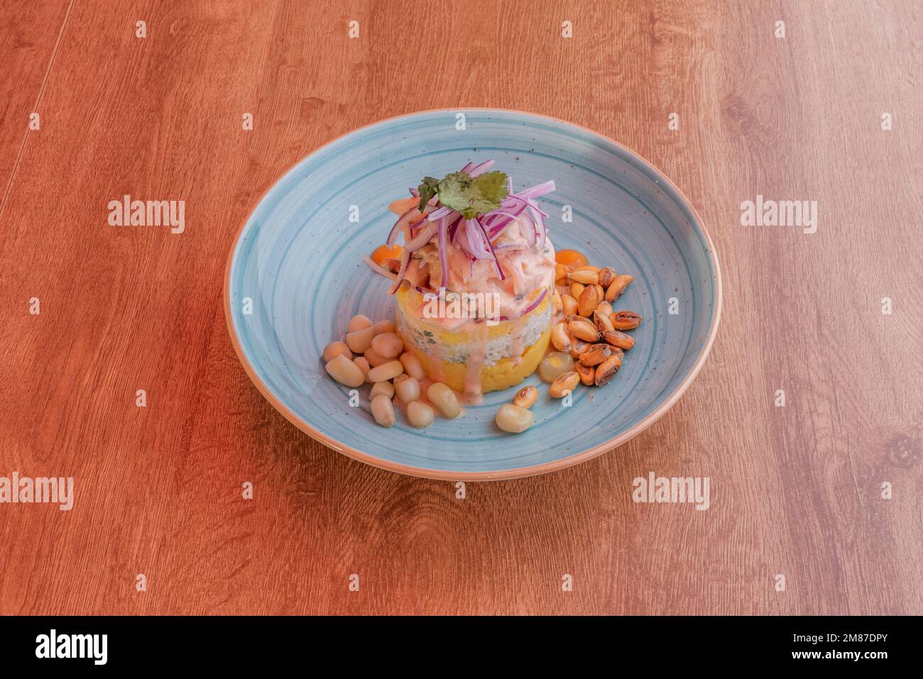 A Peruvian dish that is a mix of causa and ceviche de corvina con ...