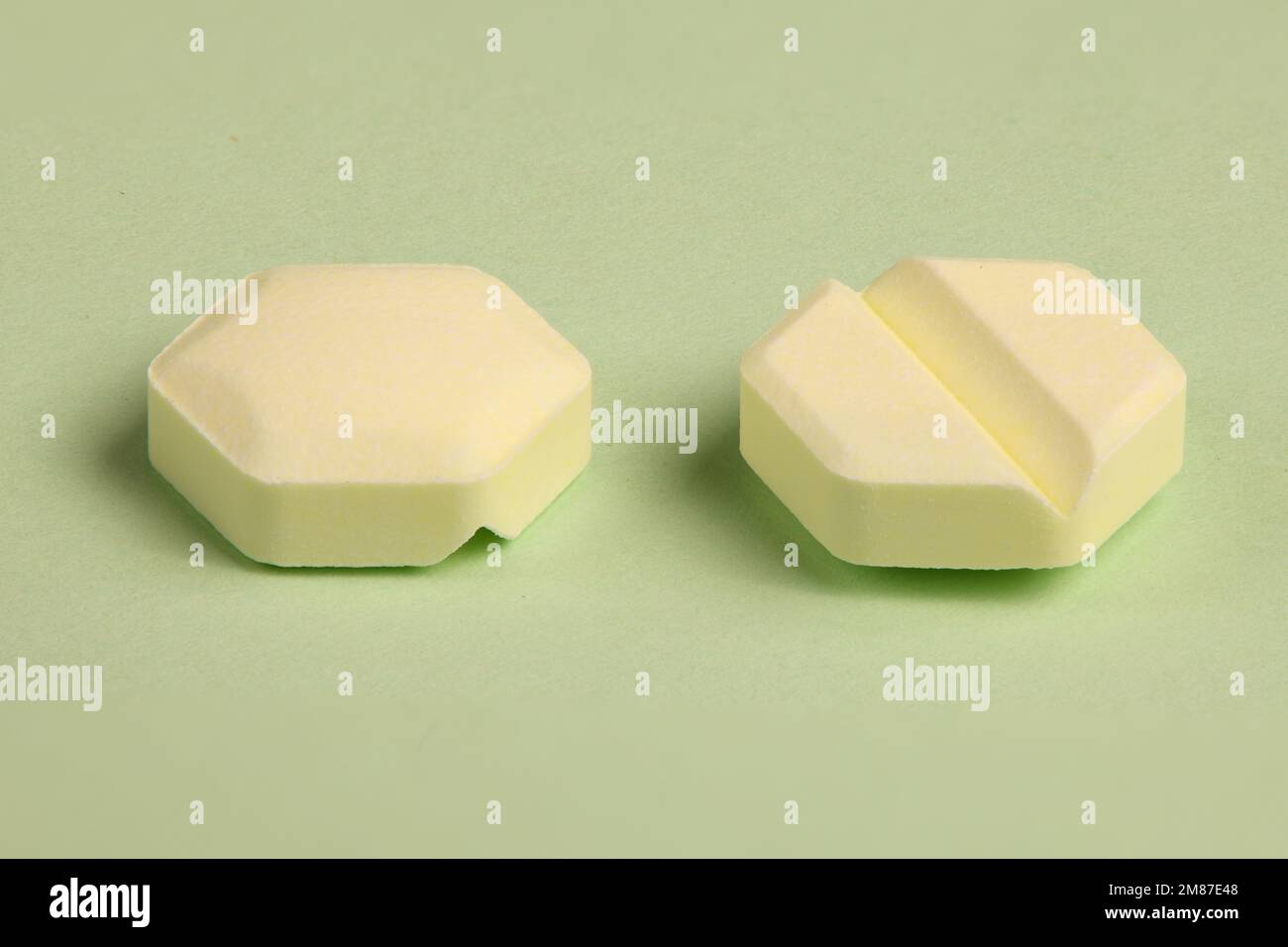 Hexagonal pills on light green background. Extreme closeup. High ...