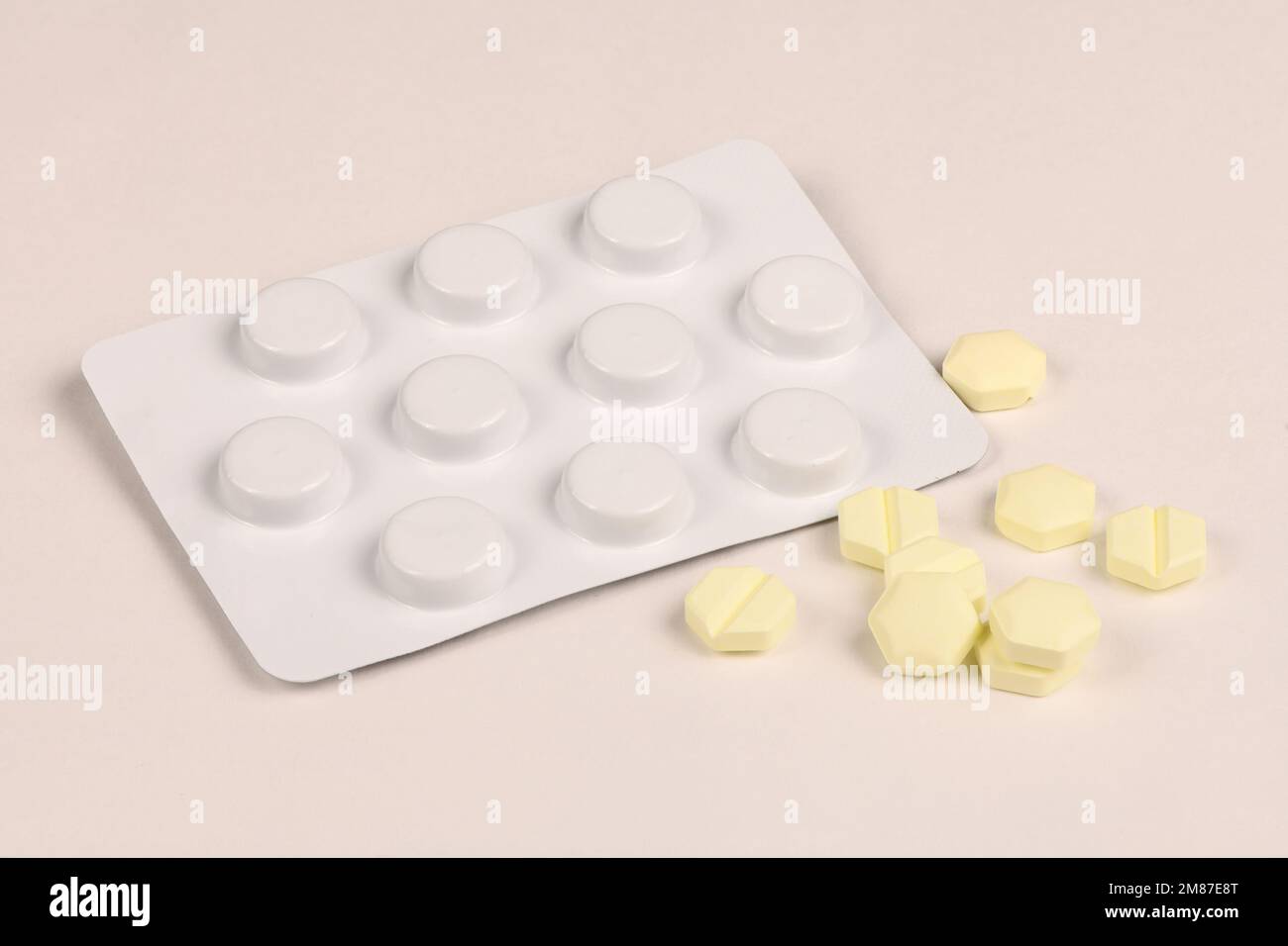 Hexagonal pills on light pink background. Extreme closeup. High ...