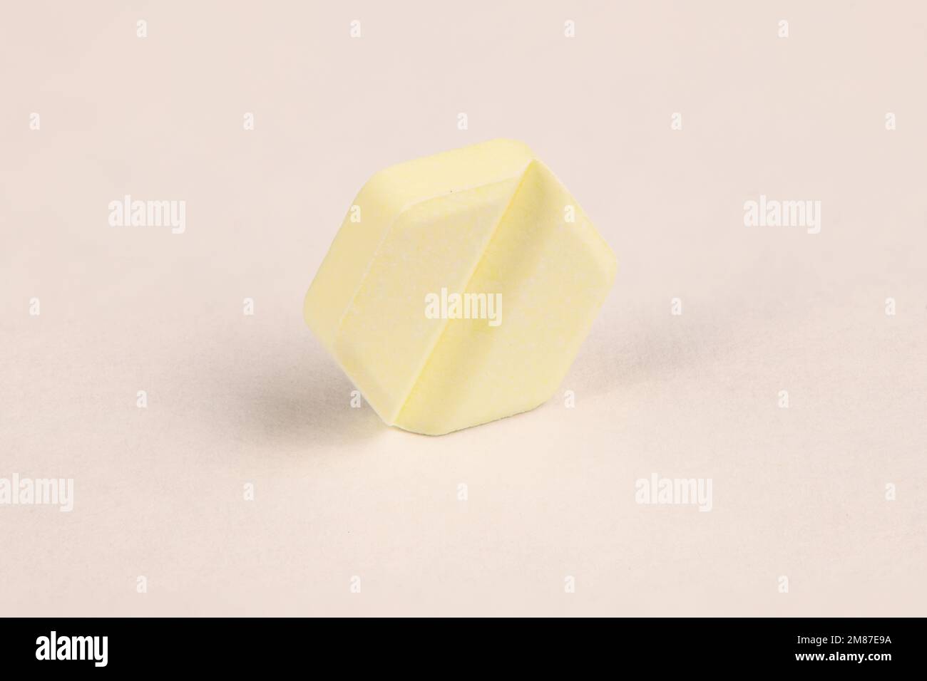 Hexagonal pills on light pink background. Extreme closeup. High ...