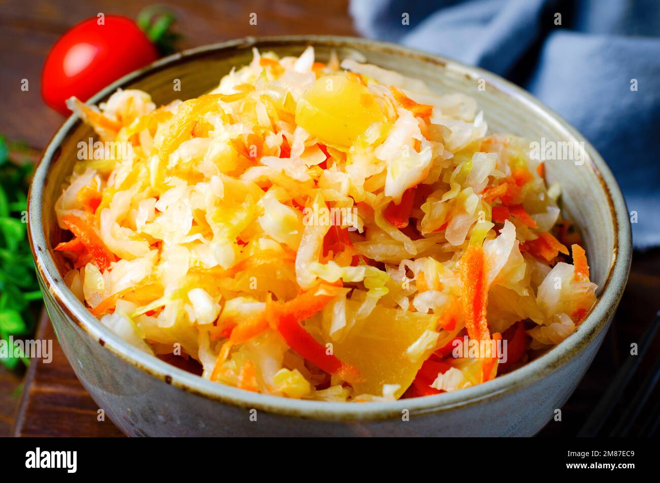 Sauerkraut, Shredded cabbage, apples, and carrots on dark rustic ...
