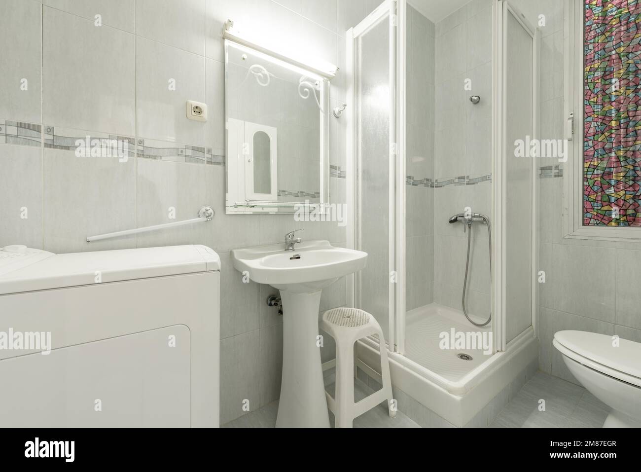 White-toned bathroom with walk-in shower, mirror, and top-loading ...