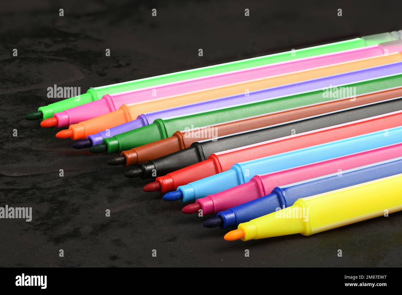 Colored markers isolated on black background. Extreme closeup. High ...