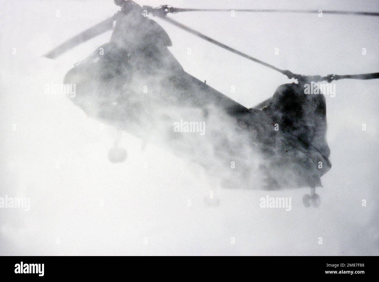 Billowing snow shrouds a Marine Corps CH-46 Sea Knight helicopter as it ...