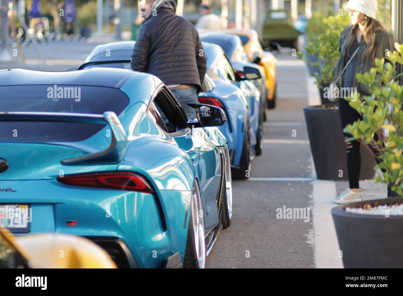 The cars parked one behind the other during the car show in the street ...