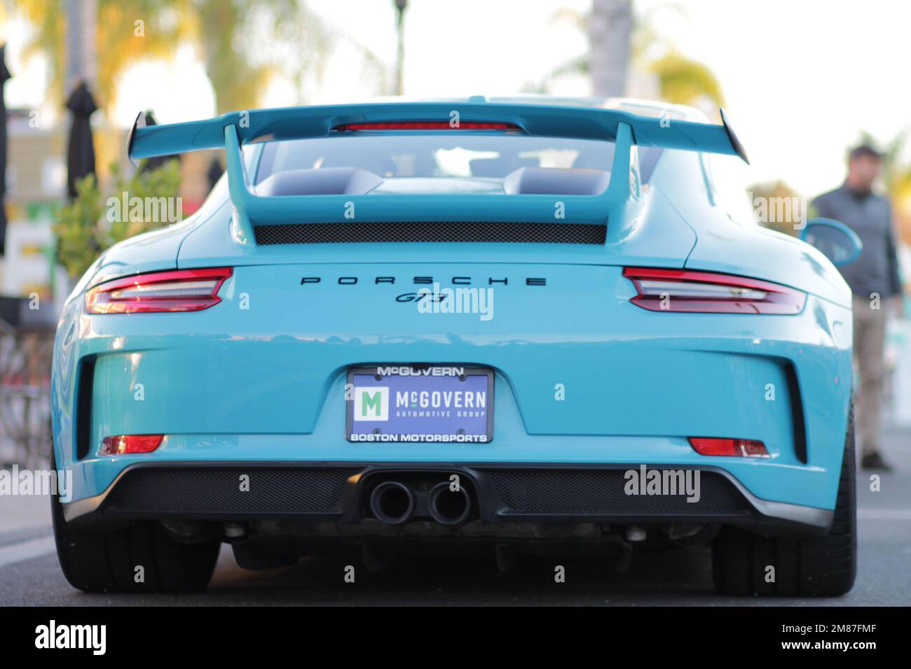 The backside of the light blue Porsche at a car show in the daytime ...