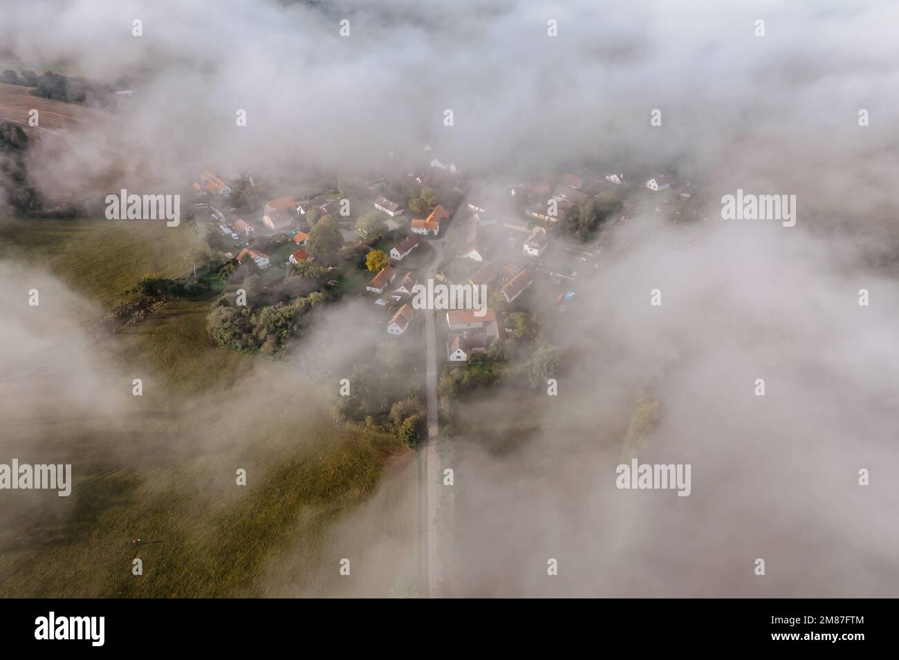 Aerial view of small village in fog.Top view of traditional housing ...