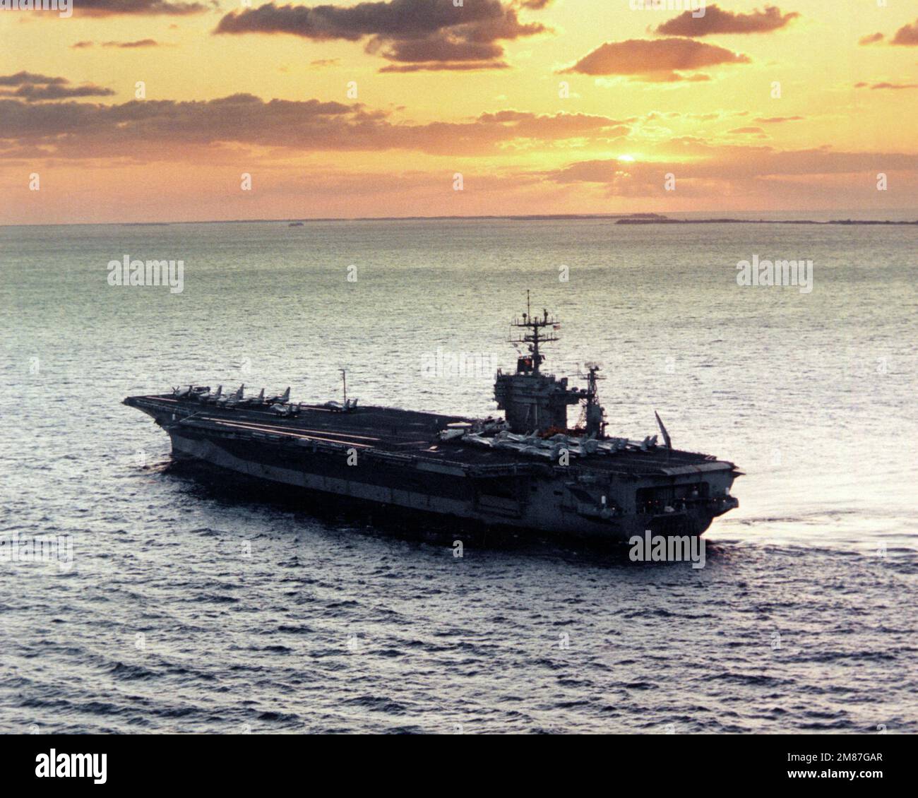 An elevated port quarter view of the nuclear-powered aircraft carrier USS THEODORE ROOSEVELT ...