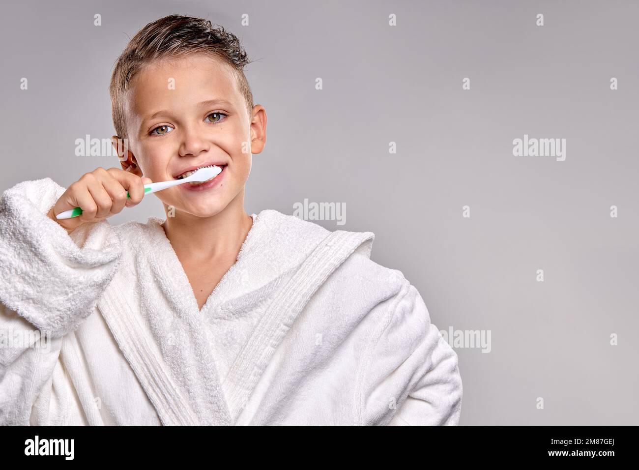 Nice little teen boy brushing teeth at morning. Child dental hygiene ...