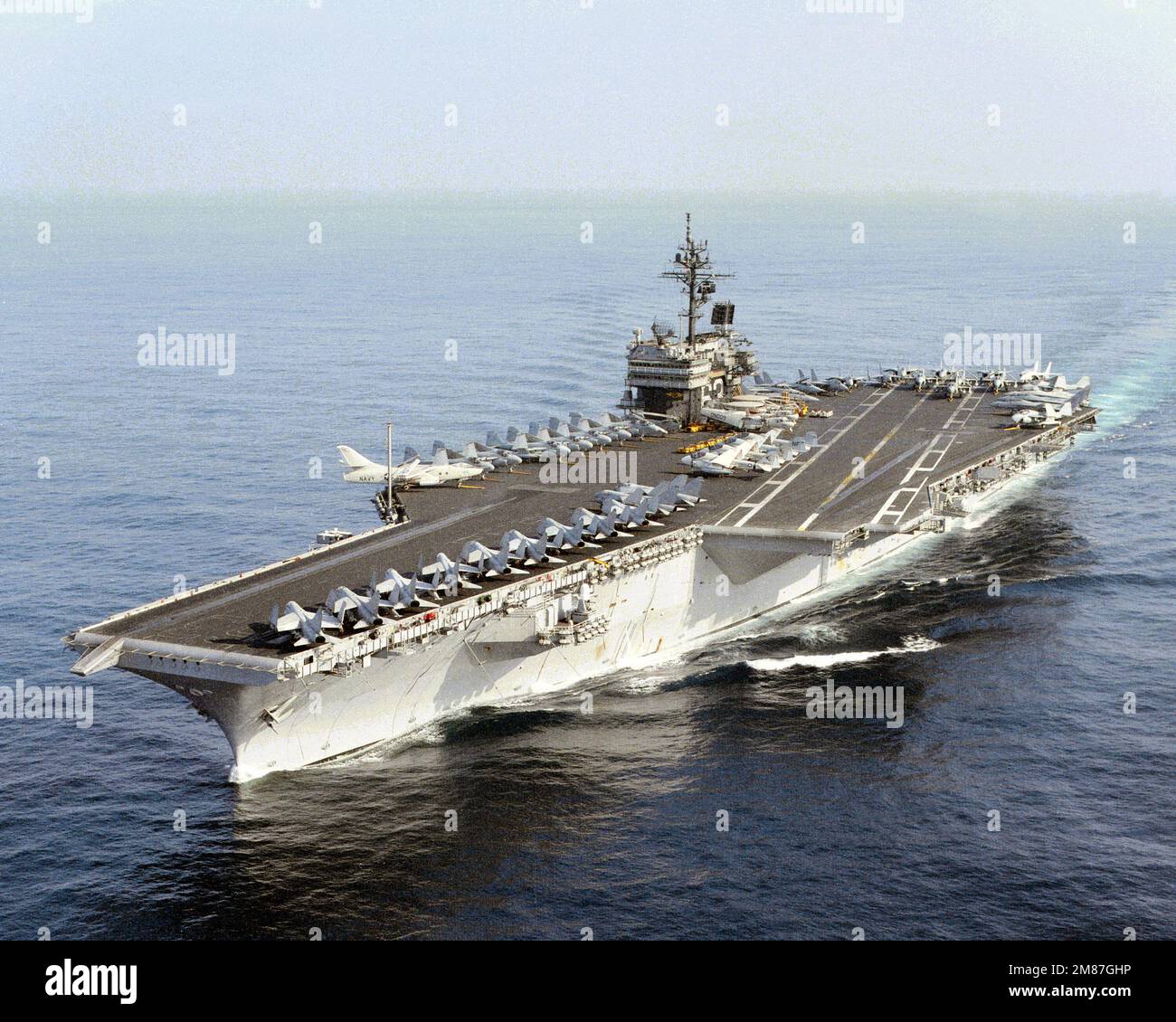 An aerial port bow view of the aircraft carrier USS KITTY HAWK (CV-63 ...