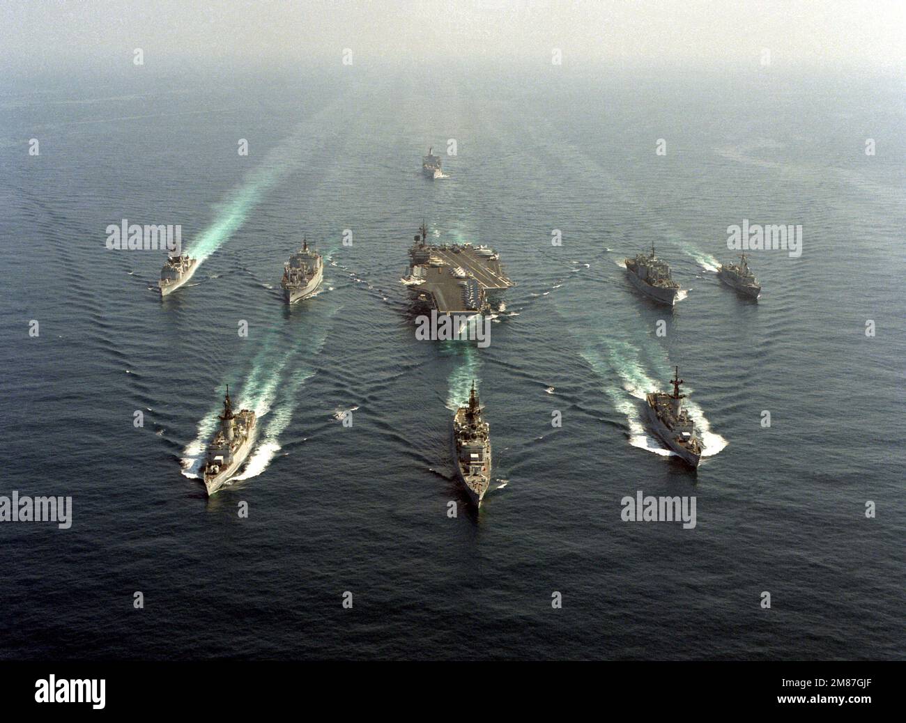 An aerial bow view of the aircraft carrier USS KITTY HAWK (CV-63) and ...