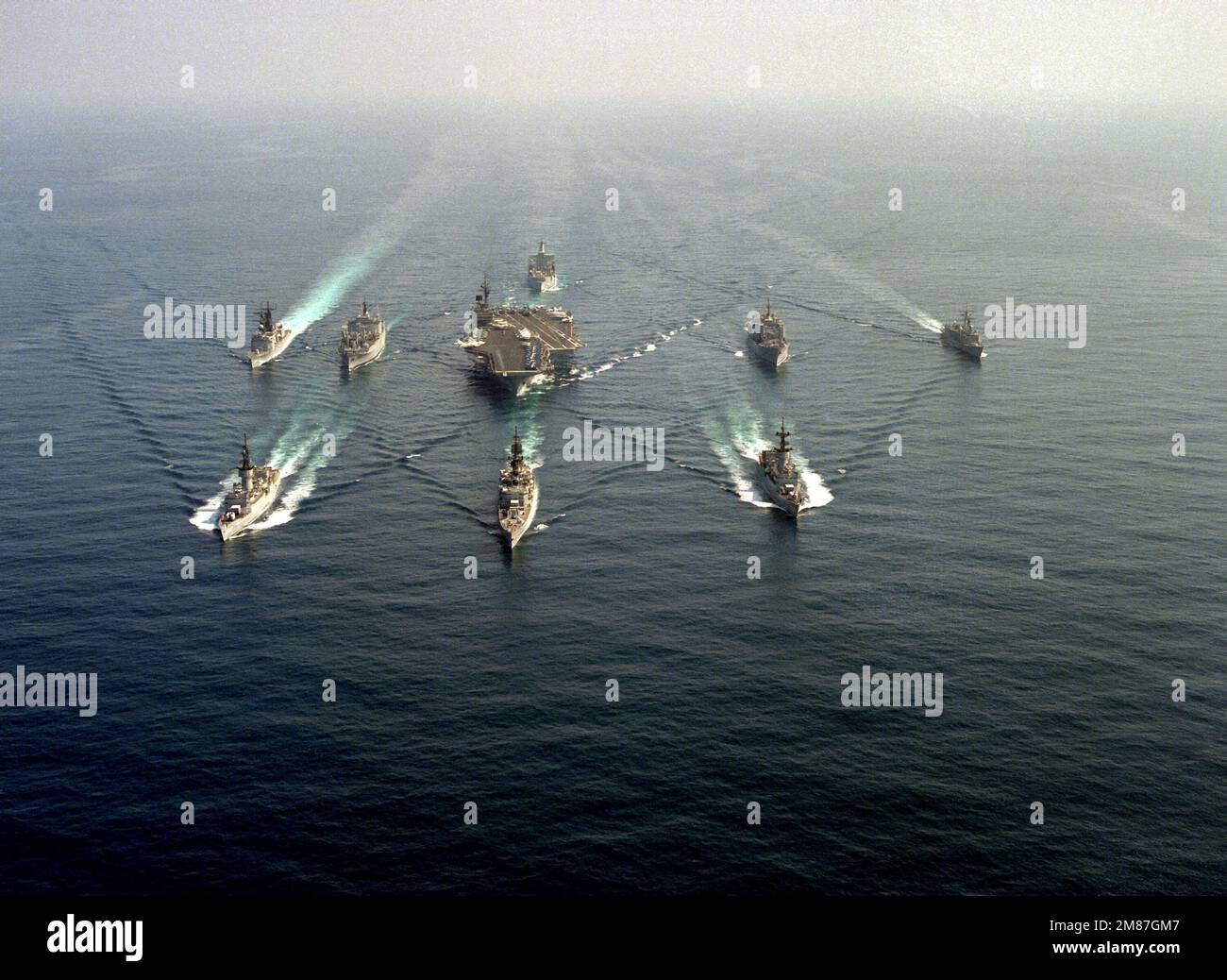 An aerial bow view of various U.S. ships of the KITTY HAWK battle group ...