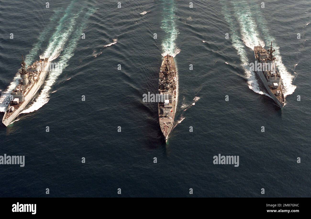 An aerial bow view of the frigate USS STEIN (FF-1065), left, the guided ...
