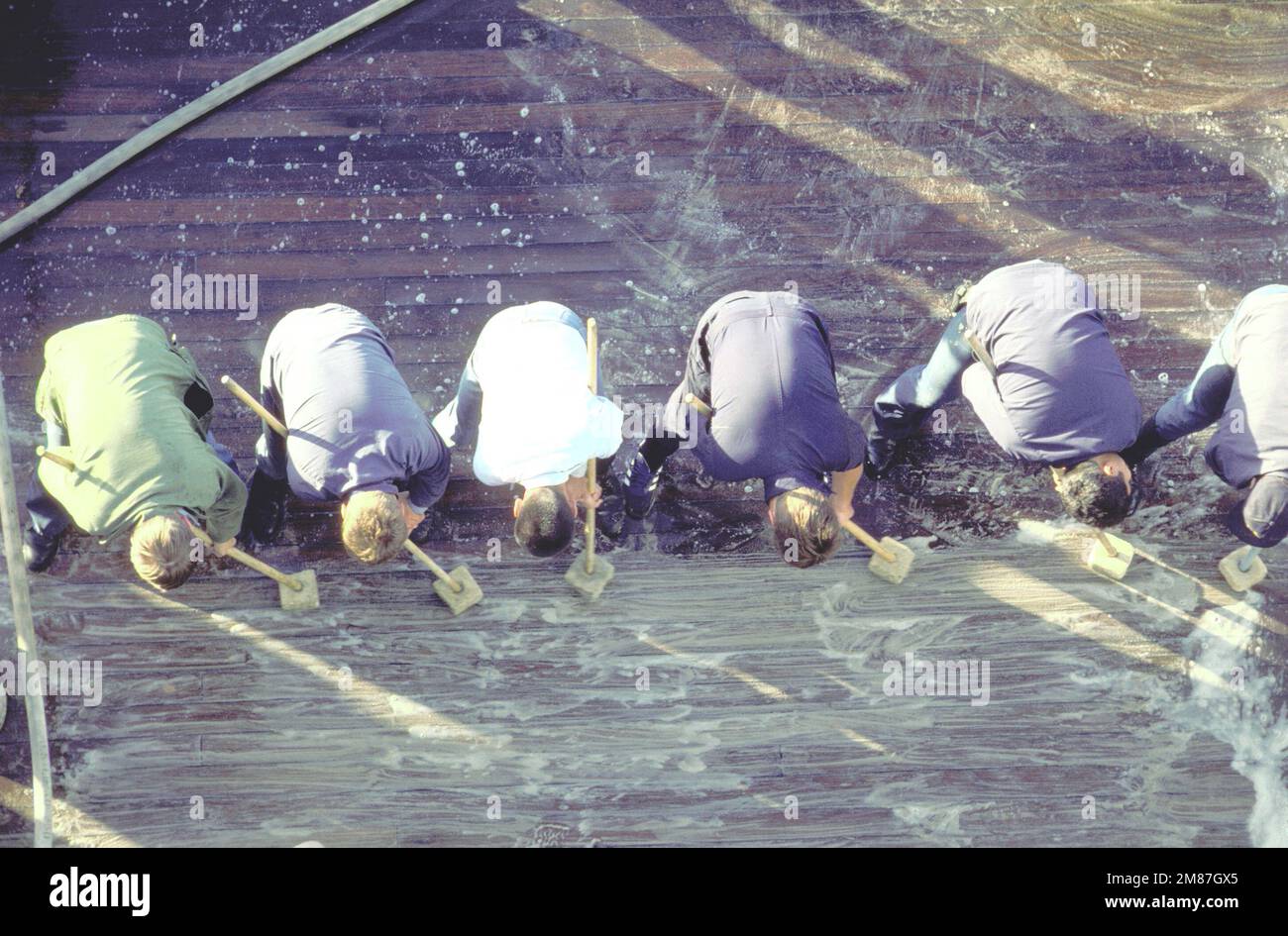Crew members aboard the battleship USS NEW JERSEY (BB-62) clean a ...