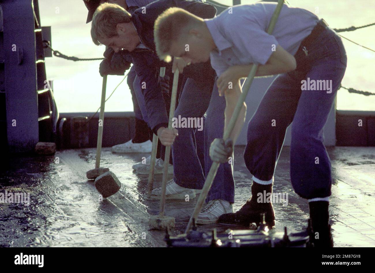 Crew members aboard the battleship USS NEW JERSEY (BB-62) clean a ...