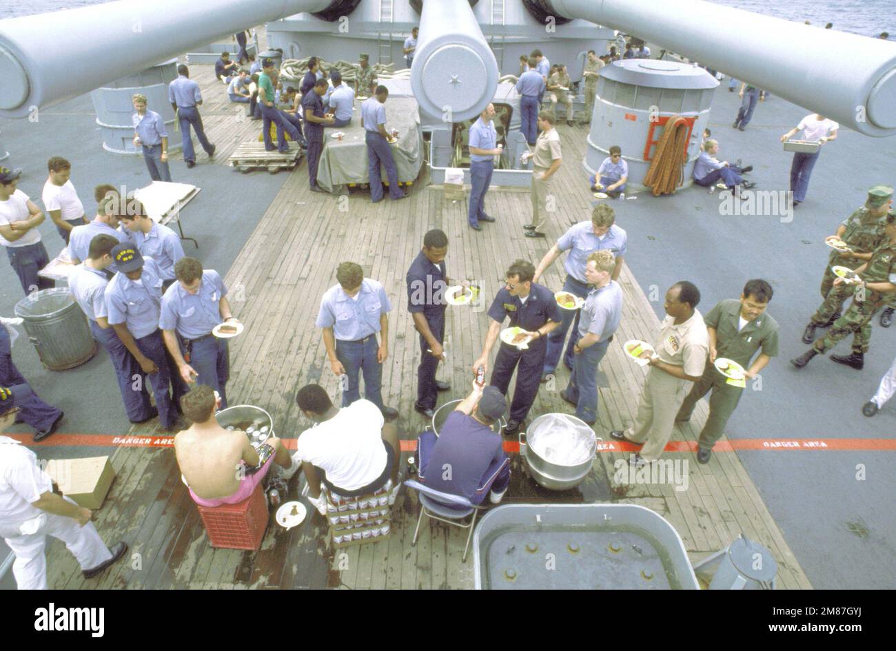Crew members aboard the battleship USS NEW JERSEY (BB-62) enjoy a cook ...